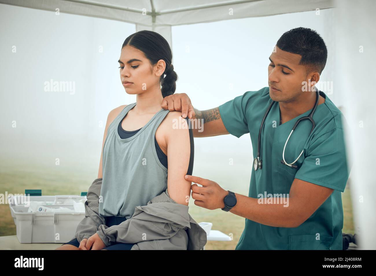 To help the pain. Cropped shot of a handsome young male physiotherapist ...
