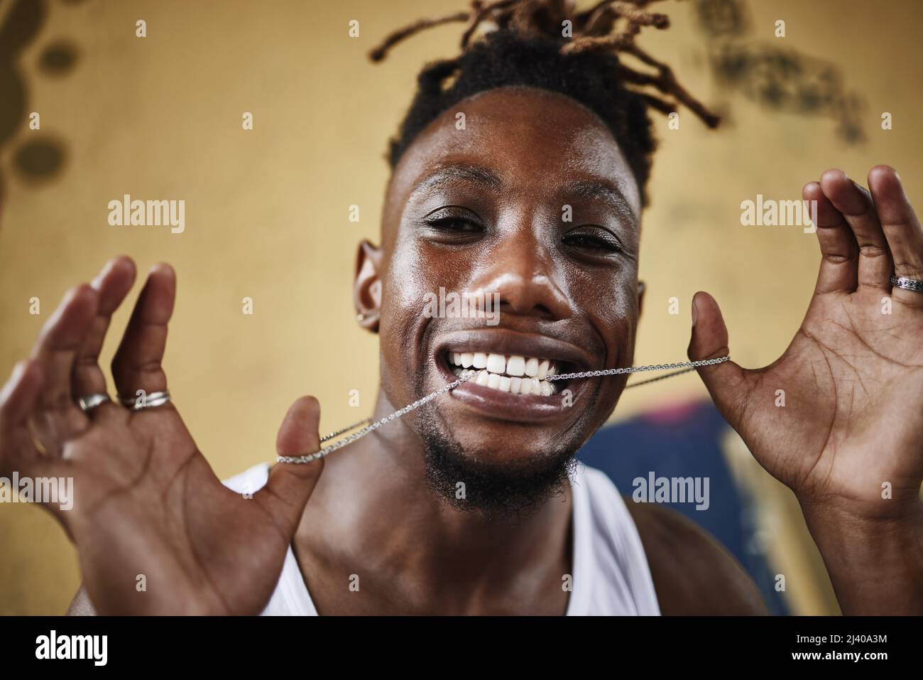 Peep my chain. Cropped portrait of a handsome young male gangster ...