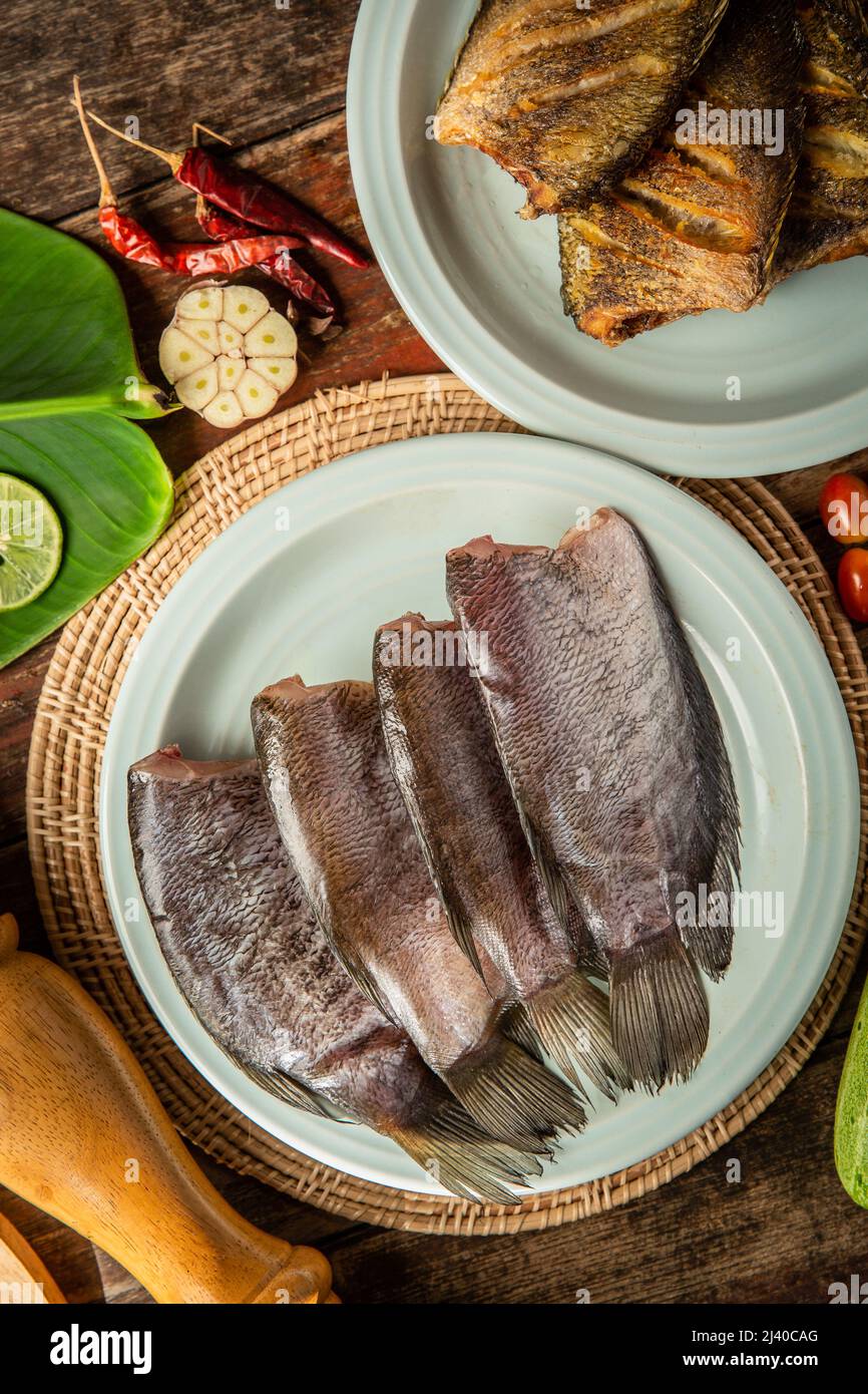 Fresh fish on the table garnished with vegetables Stock Photo - Alamy
