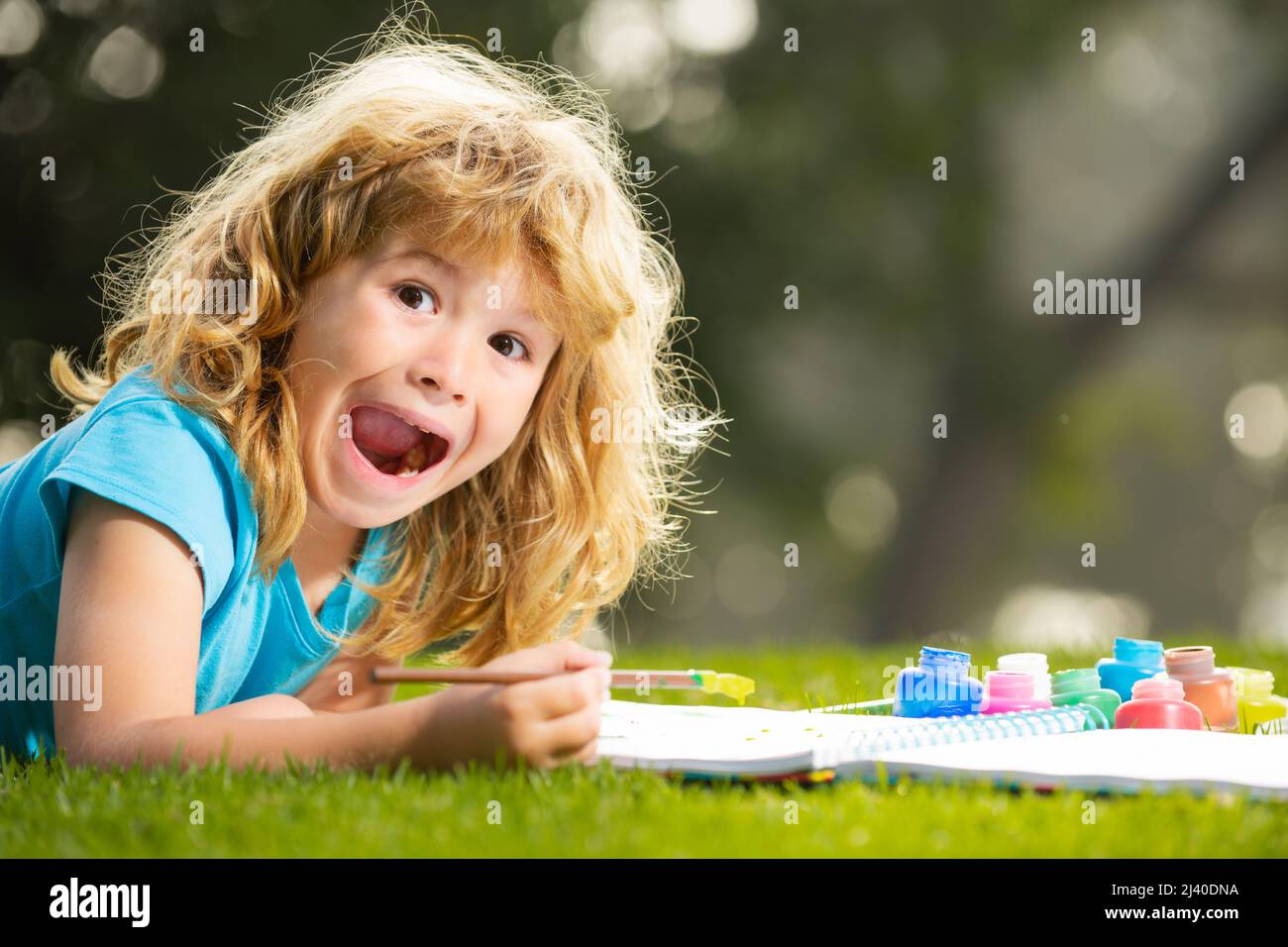 Child boy drawing in summer park, painting art. Little artist painter ...