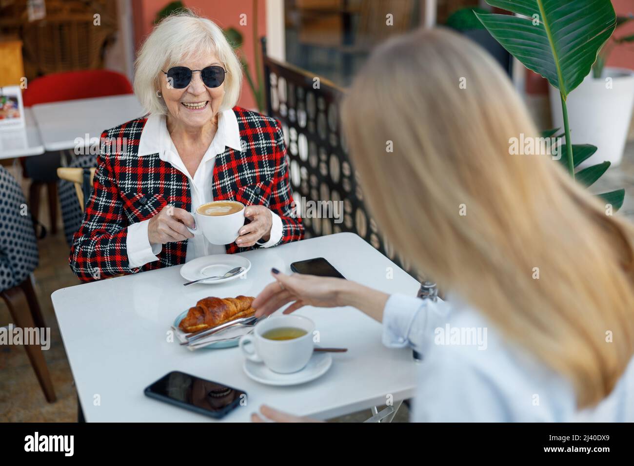Happy retired woman having coffee at street cafe Stock Photo - Alamy