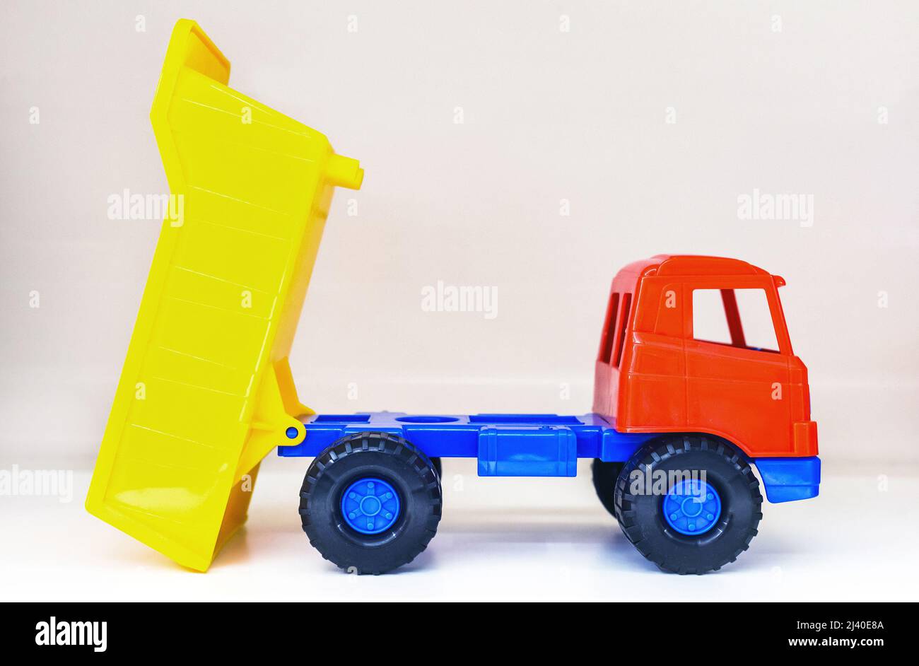 colorful plastic toy tipper dumper truck, on white (global altered ...