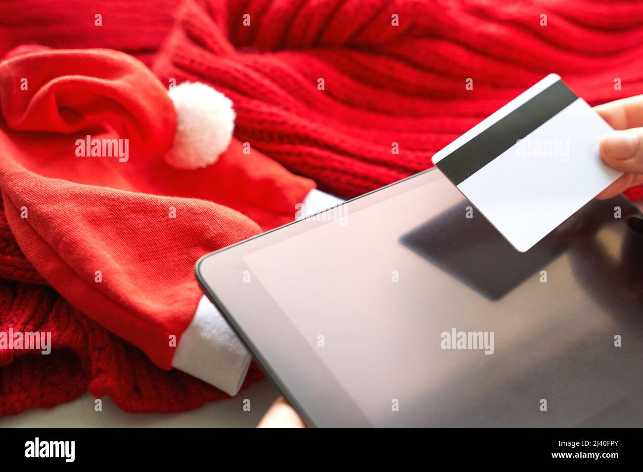 Plastic credit card mockup and tablet. Color red and white background ...