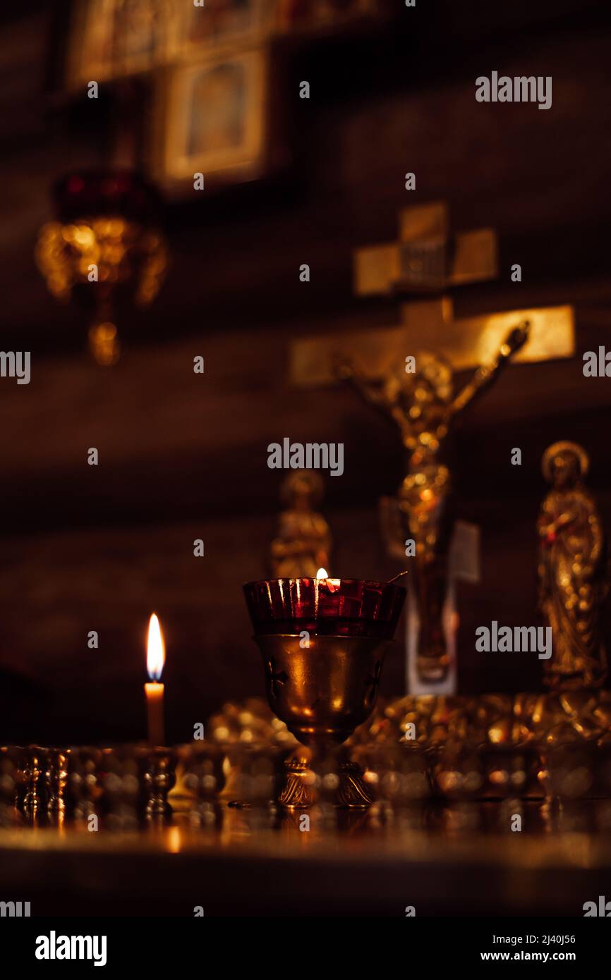 Candles on stand with candlesticks burning on altar in front of ...