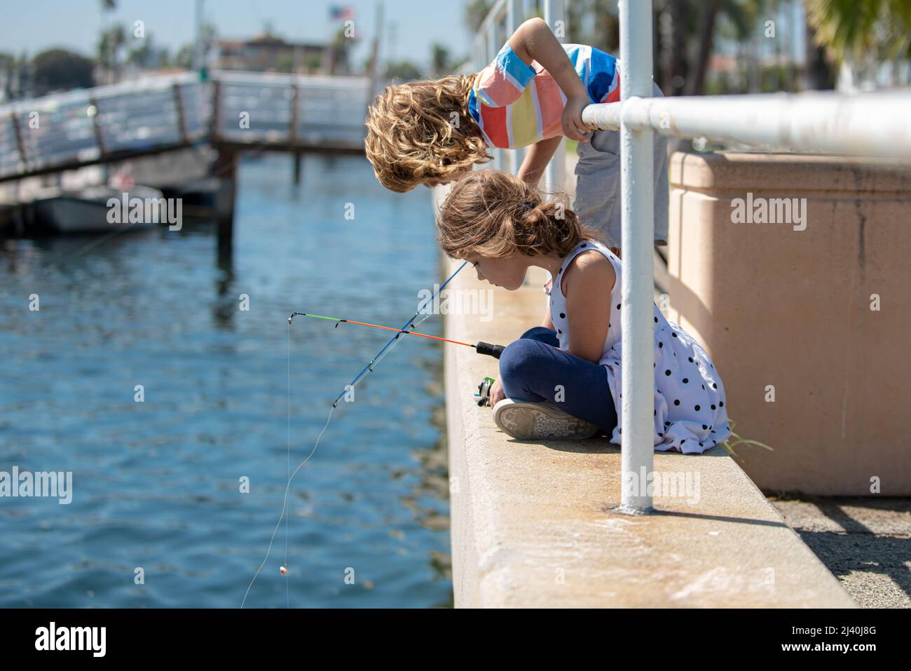Two kids boy and girl fishing in a river or lake. Happy excited ...