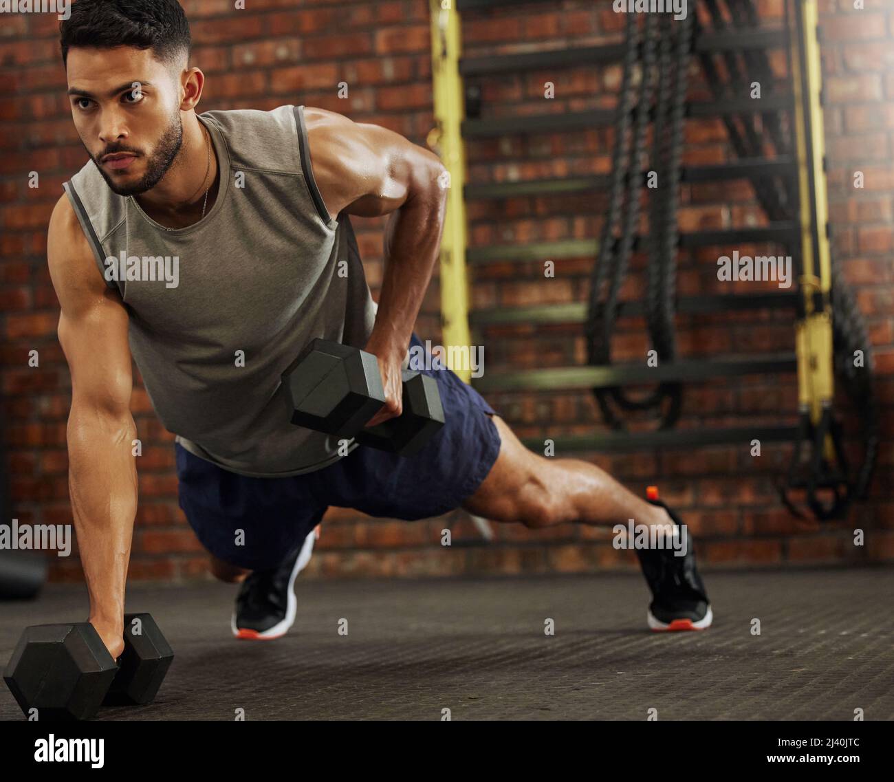 The hardest work makes the hardest bodies. Shot of a young man working ...