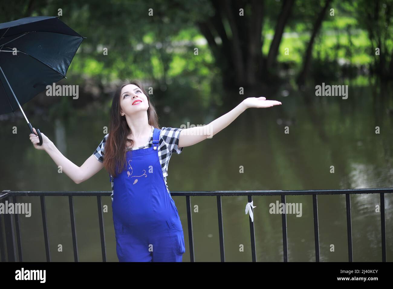 Young girl in a green park in rainy weather Stock Photo - Alamy