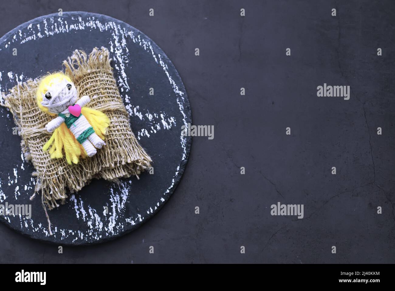 Voodoo Doll on a stone background with dramatic lighting. Mystic still ...