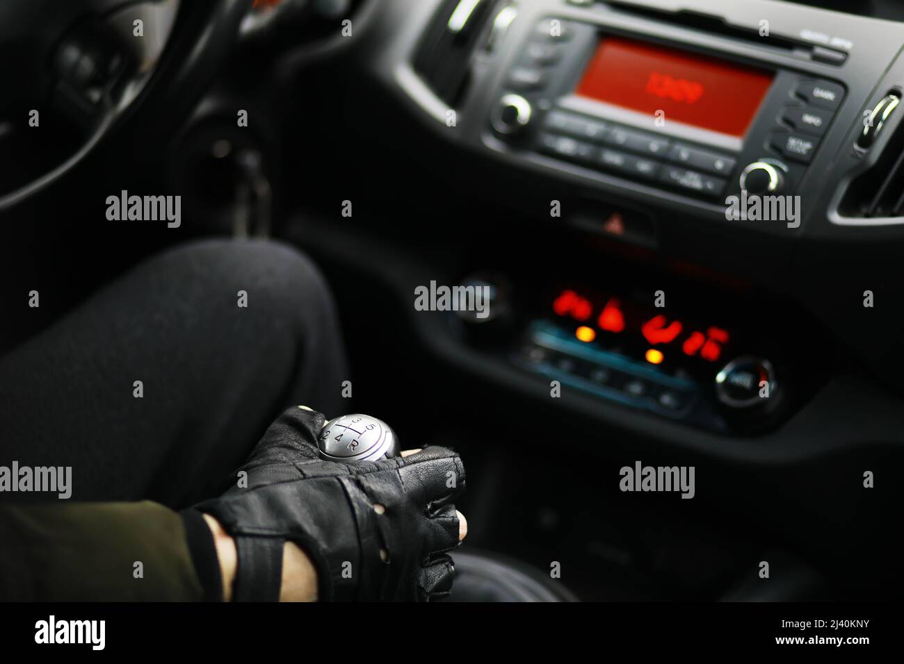Hand on car gear knob. The driver switches the speed in the car. Hand ...