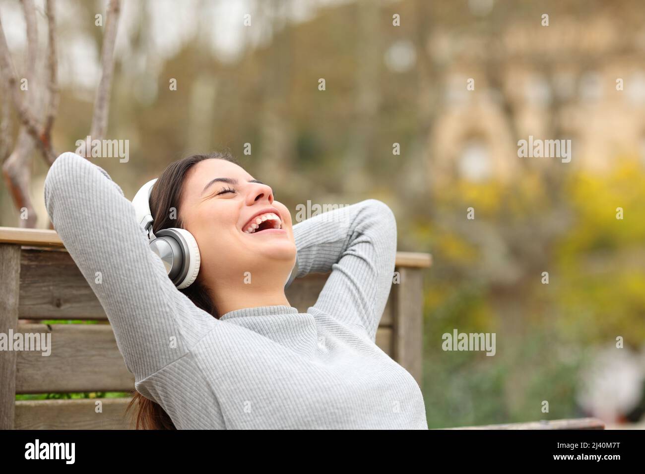 Happy Woman Listening To Music Wearing Headphones Relaxing Sitting On A