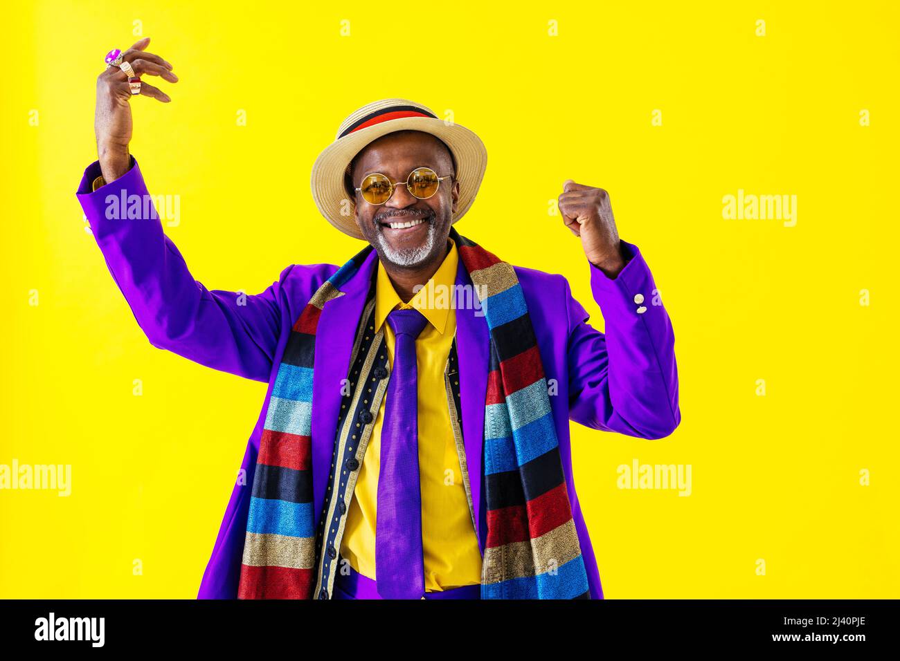 Cool senior man with fashionable clothing style portrait on colored ...