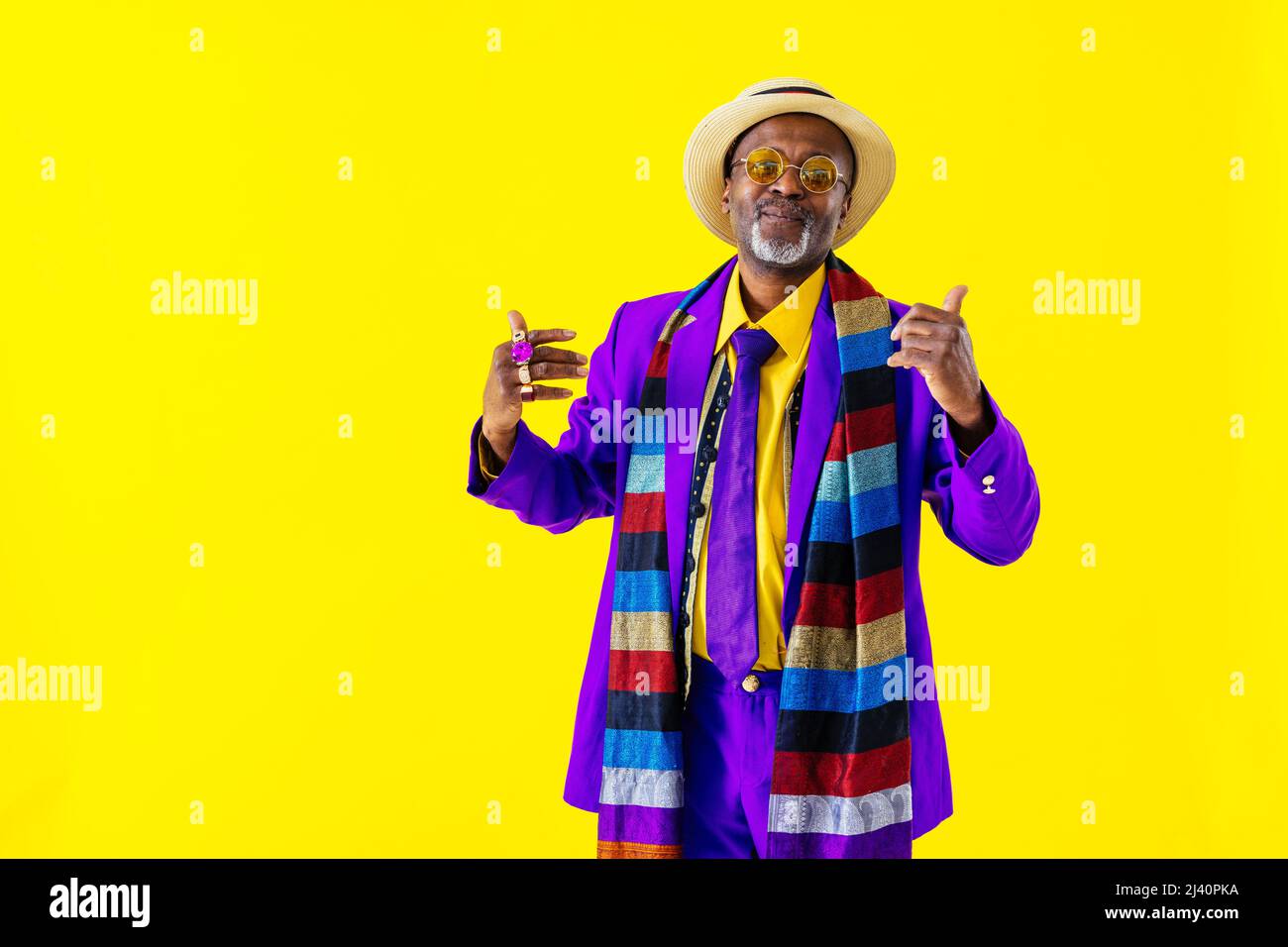 Cool senior man with fashionable clothing style portrait on colored ...