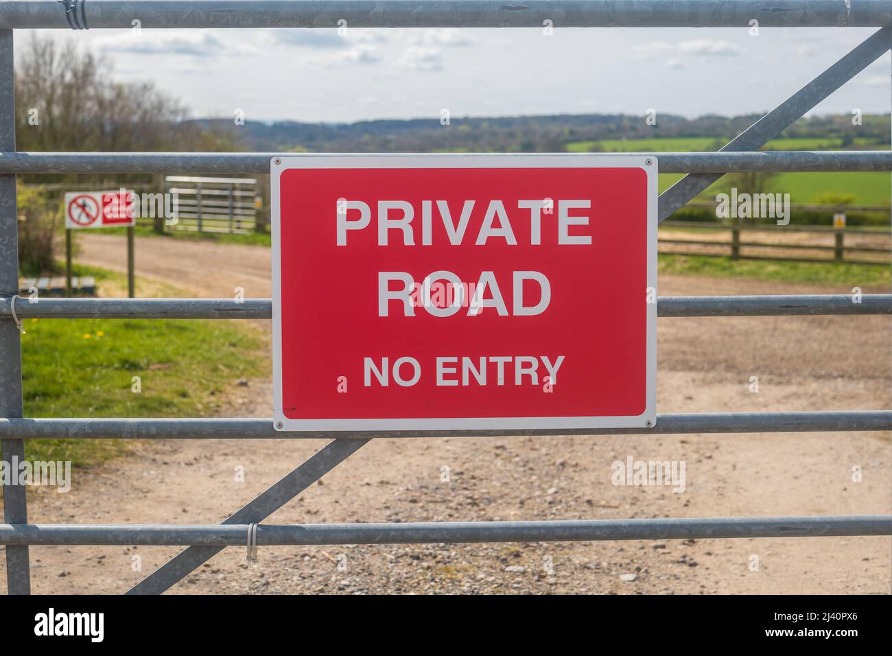 Private Road No Entry sign on a metal gate to a farm. Red and white ...