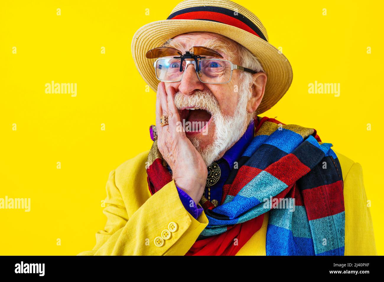 Cool senior man with fashionable clothing style portrait on colored ...
