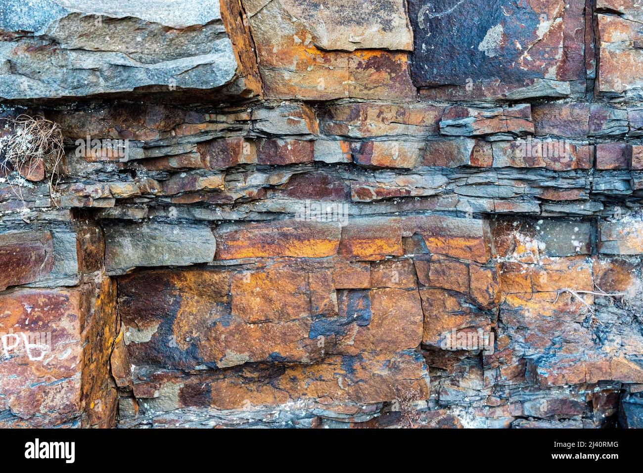 Closeup of dark dged shabby cliff cracks. Gray stone rock texture of ...
