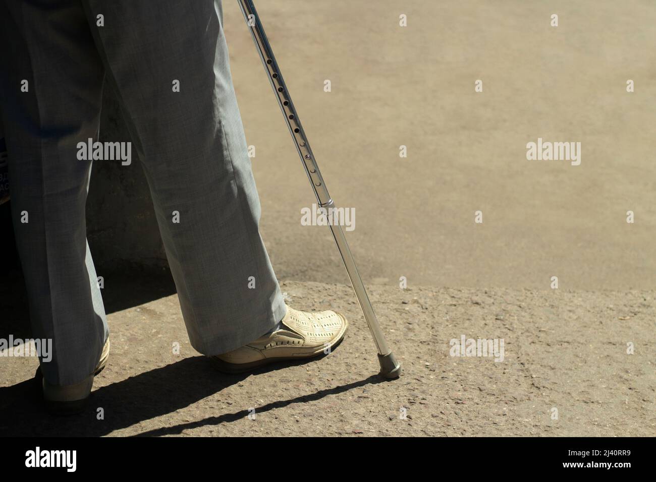 Walking stick. A man with a leg injury. Disabled with a device for ...