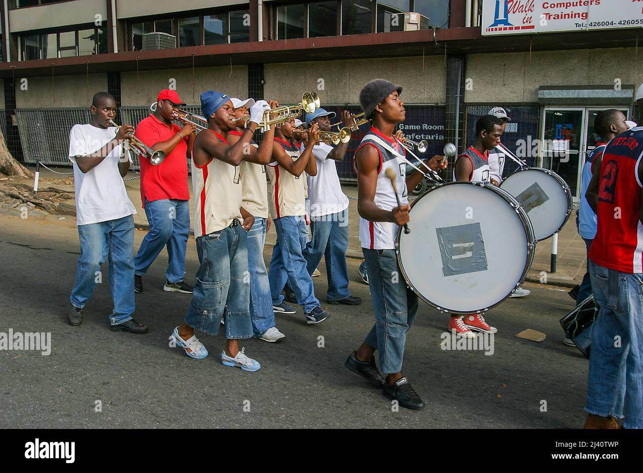 Surinam, Paramaribo - a brassband walks through the centre of the city ...