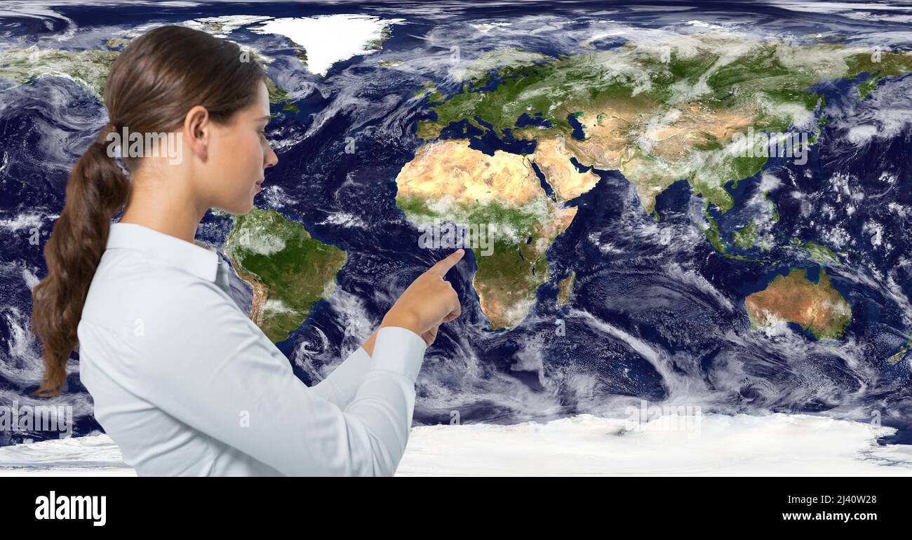 Caucasian woman touching an invisible screen against world map in ...
