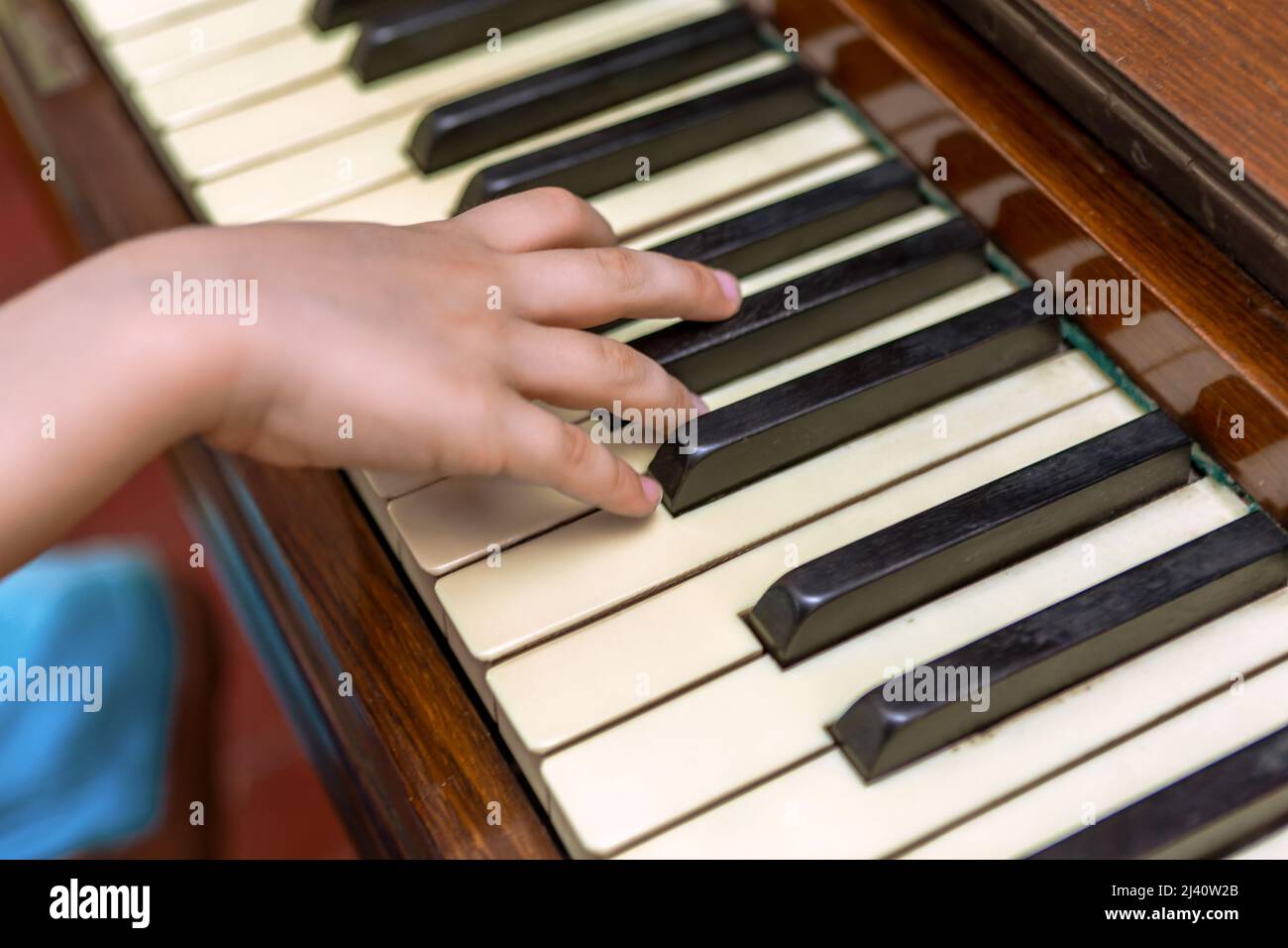 child's hands on piano keys, close-up photography Stock Photo - Alamy