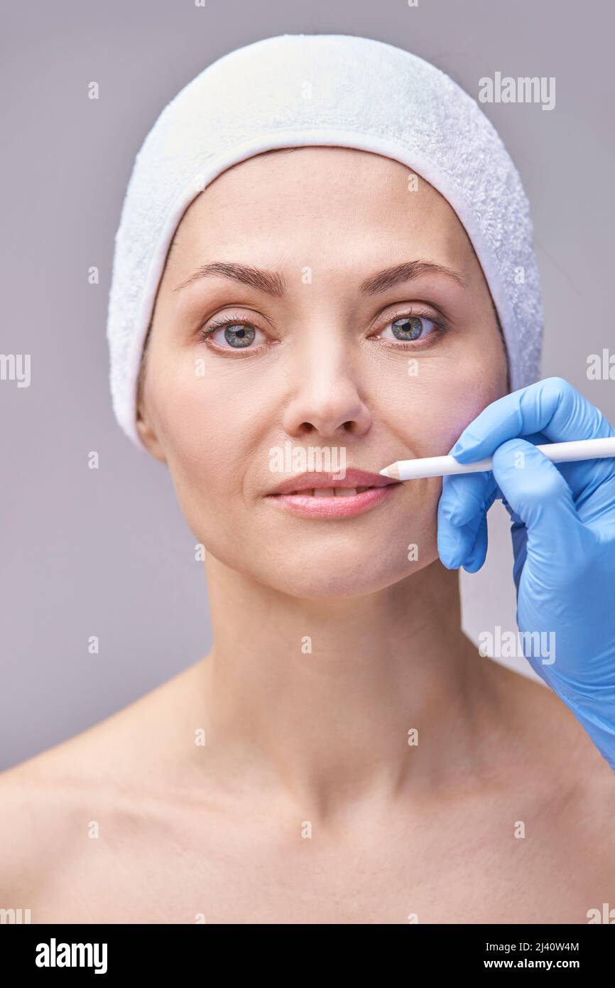 Beautician skin care. Face pencil make up. Facial treatment. Woman ...