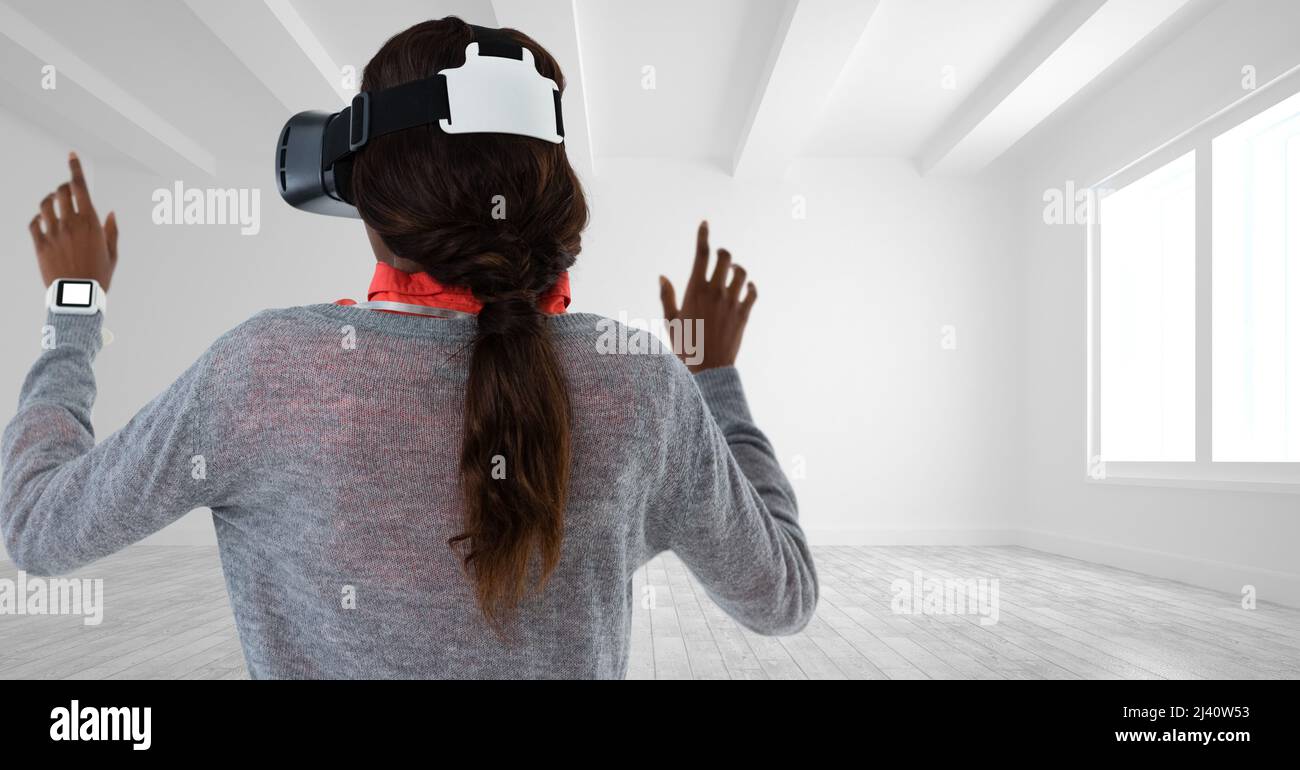 Rear view of african american businesswoman wearing vr headset against ...
