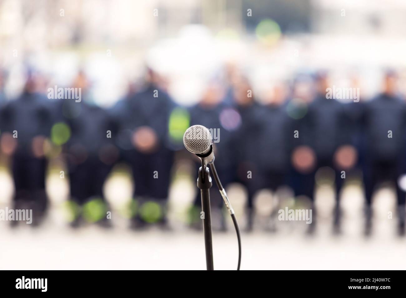 Focus on microphone, blurred crowd of people in the background Stock ...