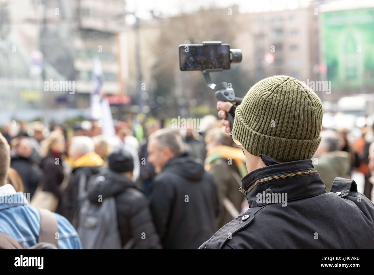 Mobile journalist filming protest with a smartphone Stock Photo - Alamy
