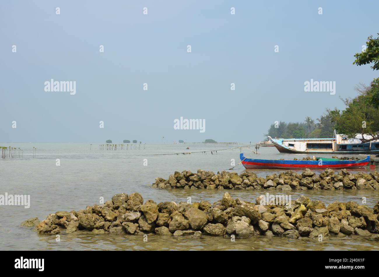 Wave breakers and wooden boats Stock Photo - Alamy