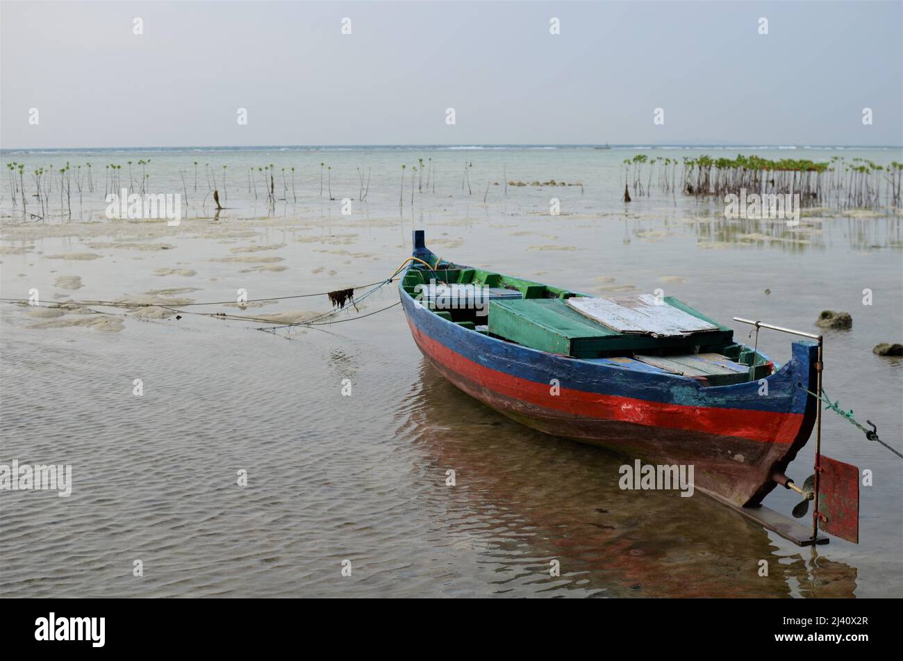 A wooden boat floating on water Stock Photo - Alamy