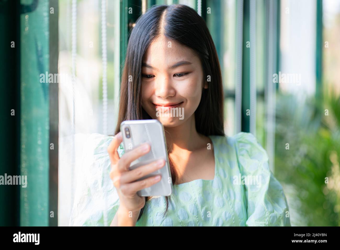Portrait of business asian women using smartphone online network while ...