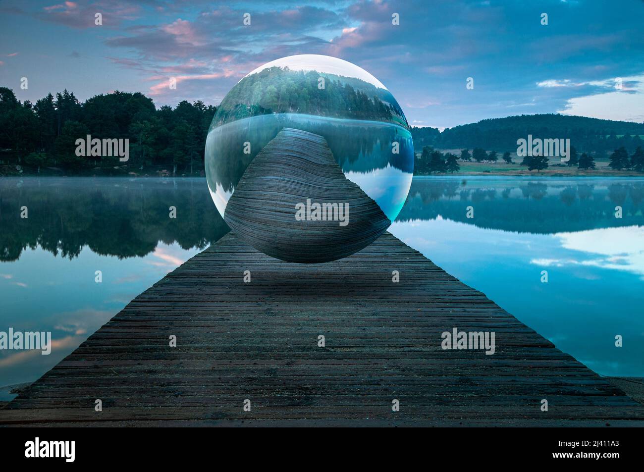 surreal sphere floating in the middle of a beautiful landscape ...