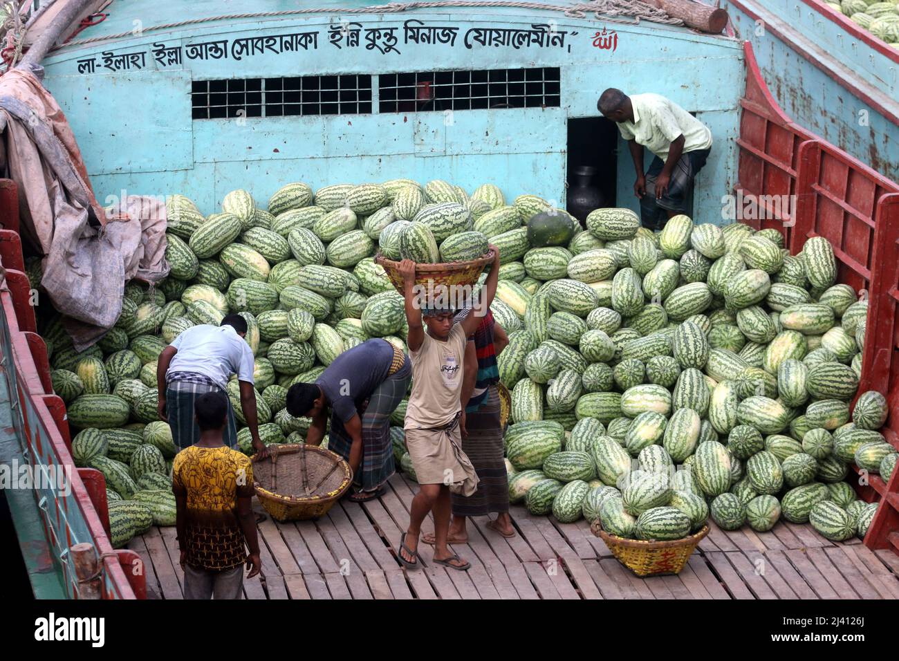 DHAKA,BANGLADESH,APRIL 09,2022: Traders are bringing watermelon from Patuakhali to Dhaka by boat ...