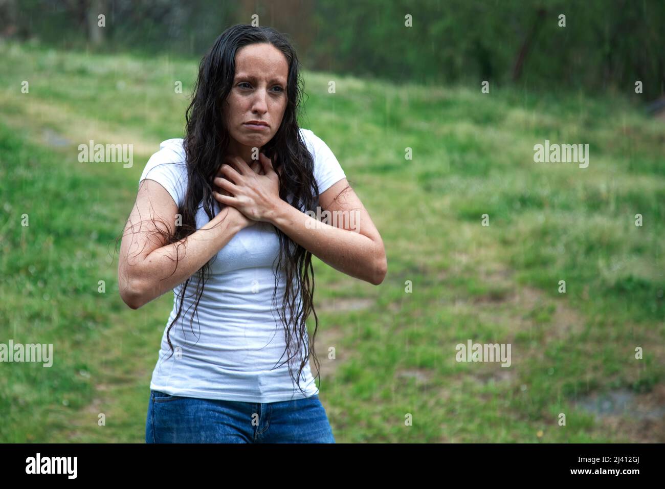 woman in her 30's showing sadness and anguish, holding her hands to her ...