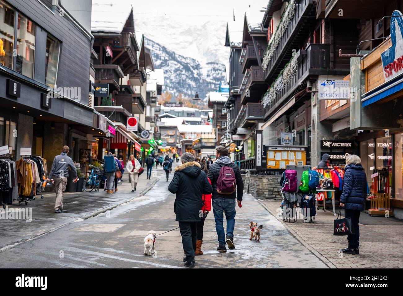 Zermatt, Switzerland - November 11, 2019: Tourists walking with dogs on ...