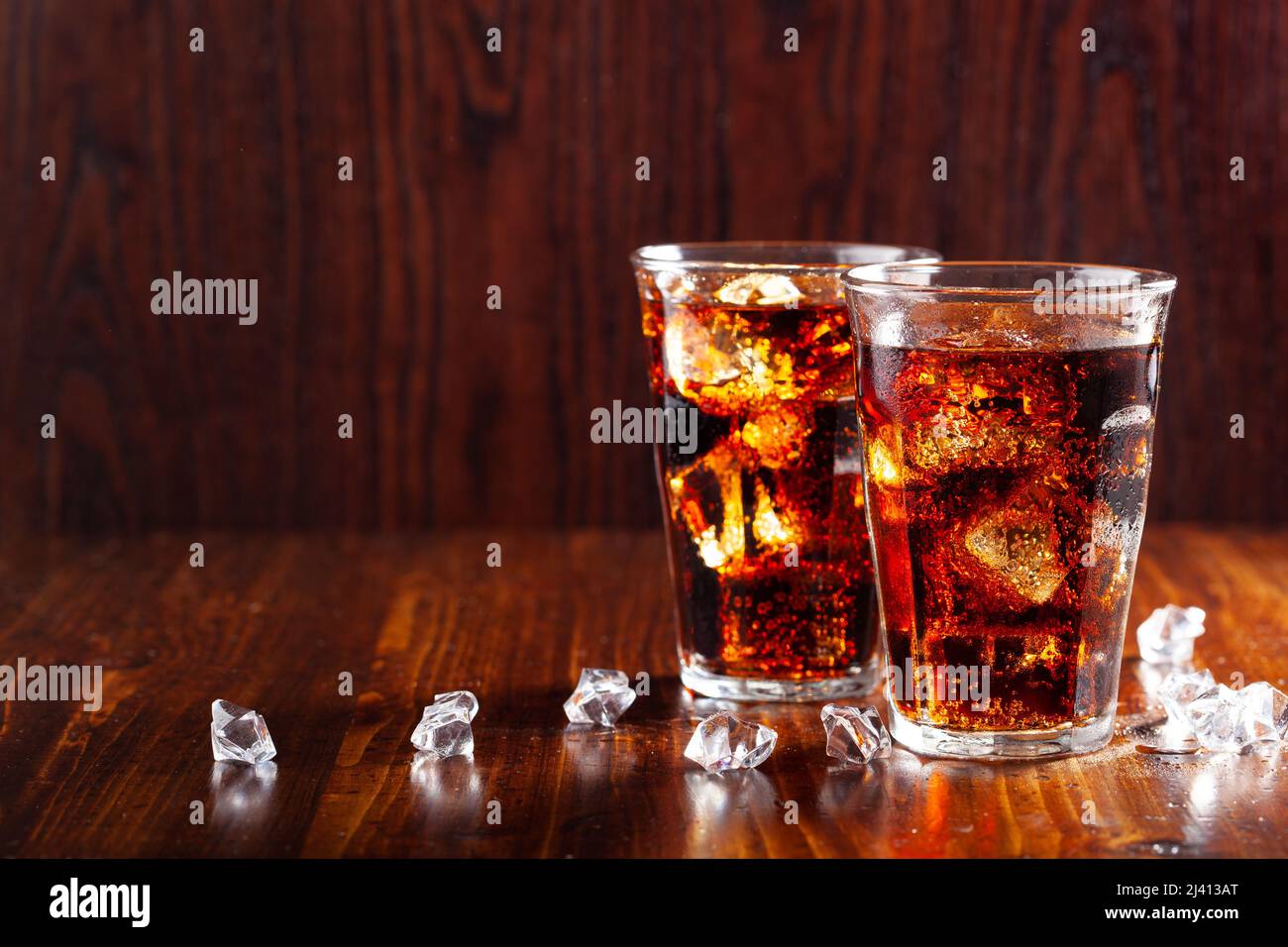 glass of cold cola soft drink with ice on wooden background Stock Photo ...