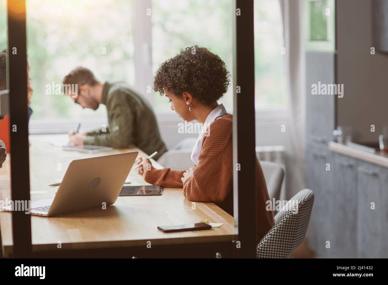 multinational business team works in a modern hall of the cowork Stock ...