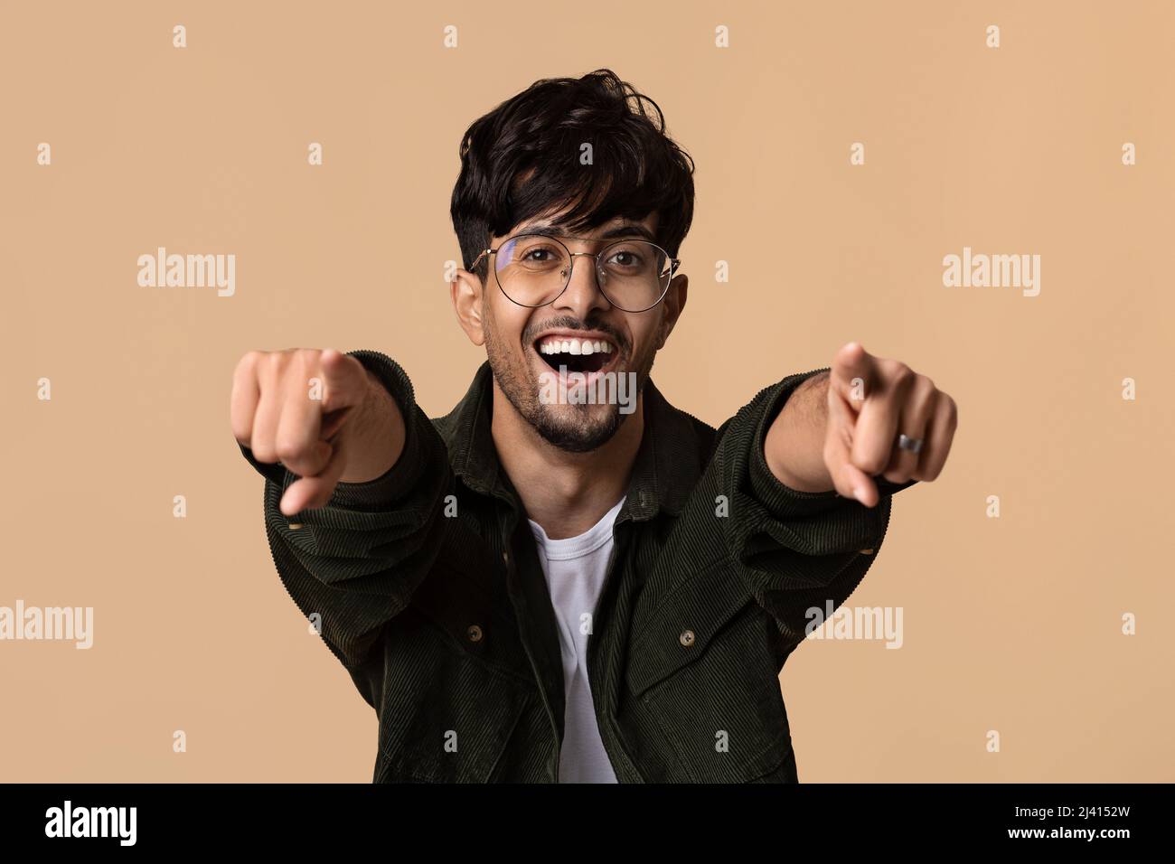 Joyful handsome middle eastern guy pointing at camera Stock Photo - Alamy