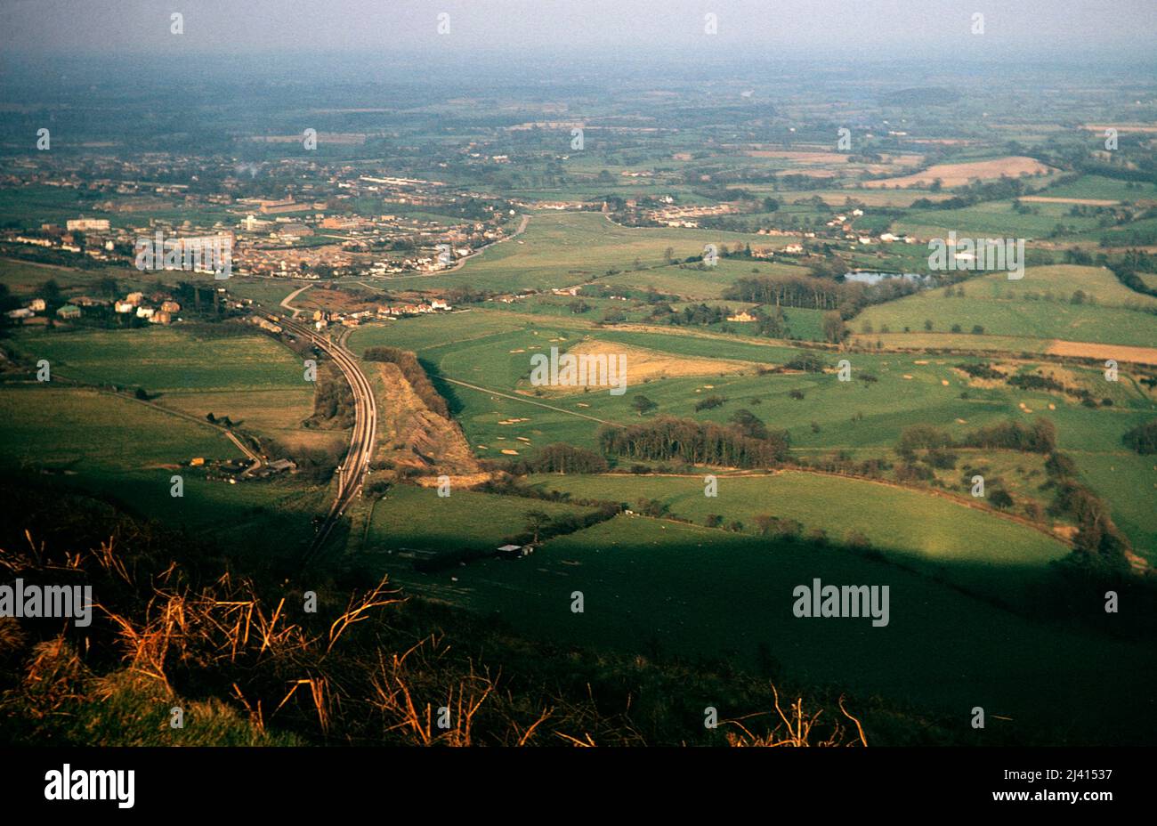 View over railway line emerging from Malvern Hills and town of Great ...