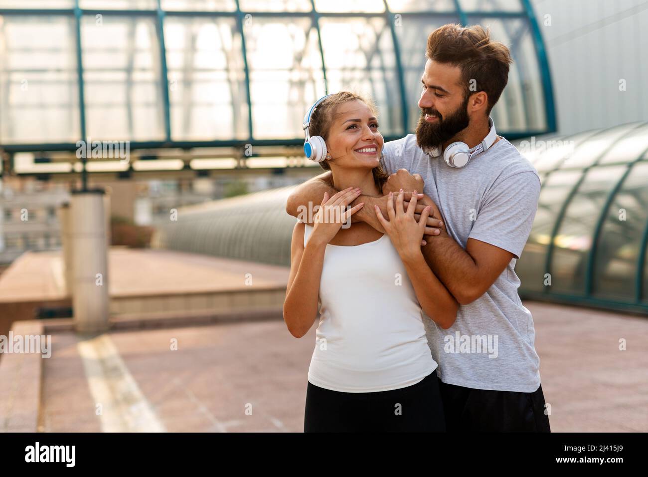Happy runner couple exercising outside as part of healthy lifestyle ...