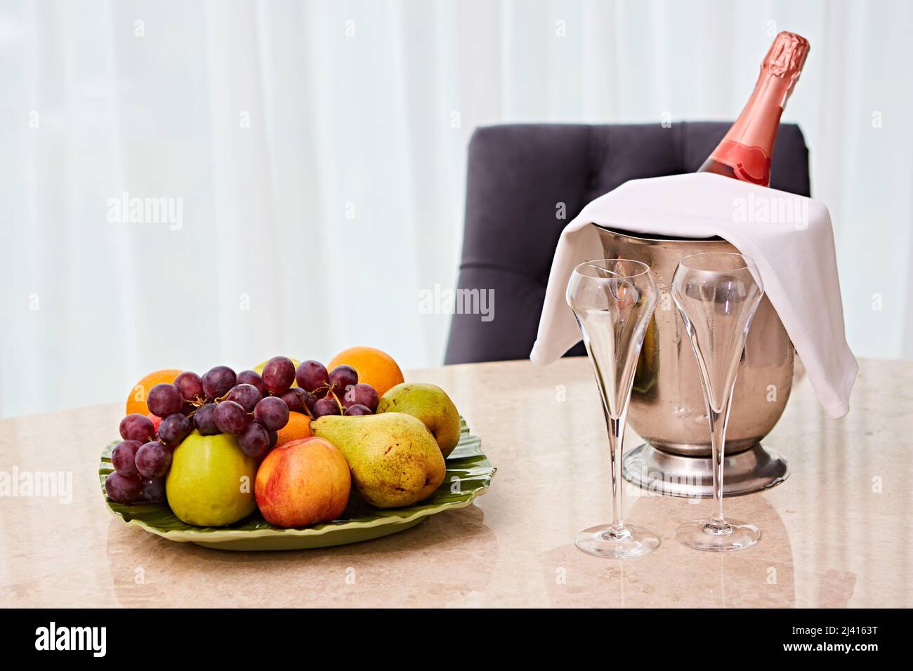Champagne in a Hotel Room, Ice Bucket, Glasses and Fruits on a Plate ...