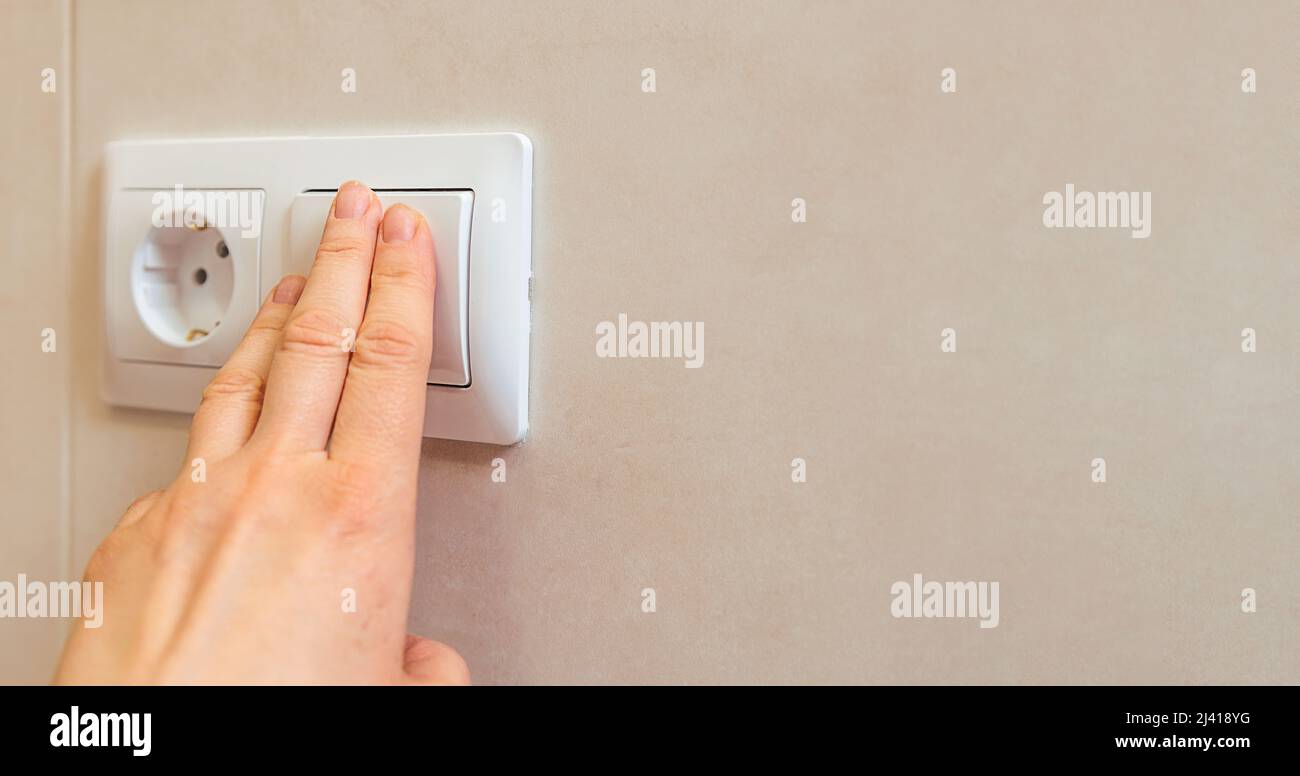 Womans hand light switch hi-res stock photography and images - Alamy