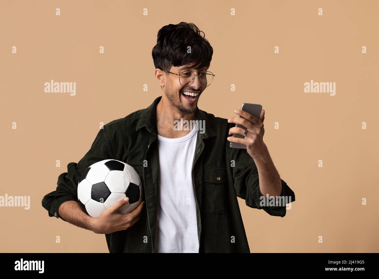 Football fan using mobile phone hi-res stock photography and images - Alamy