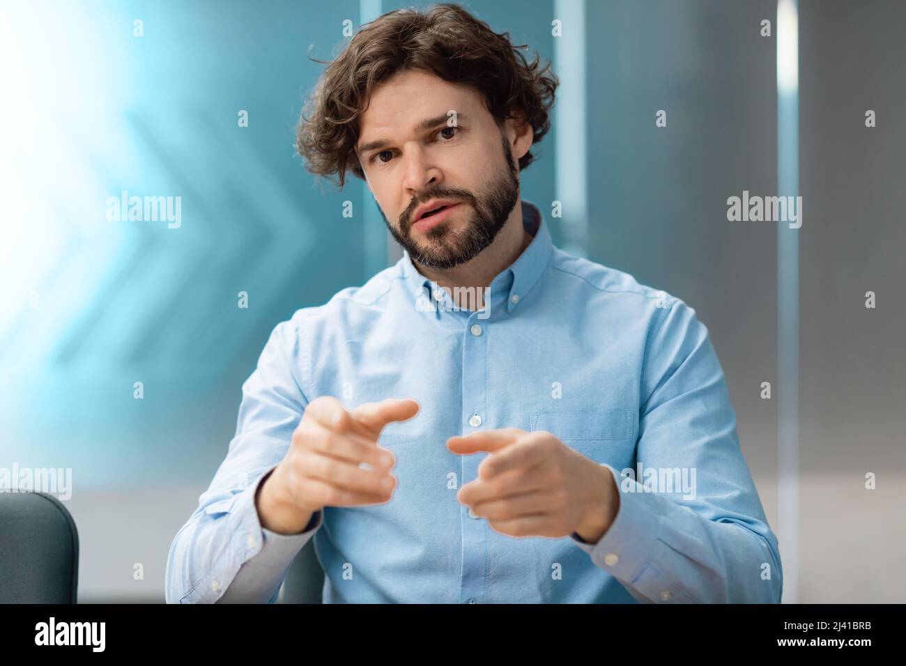Confident man talking to camera making video call Stock Photo - Alamy