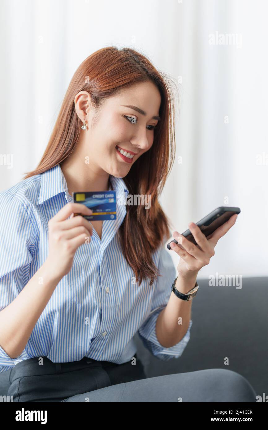Woman using shopping application by cell phone and payment by credit ...