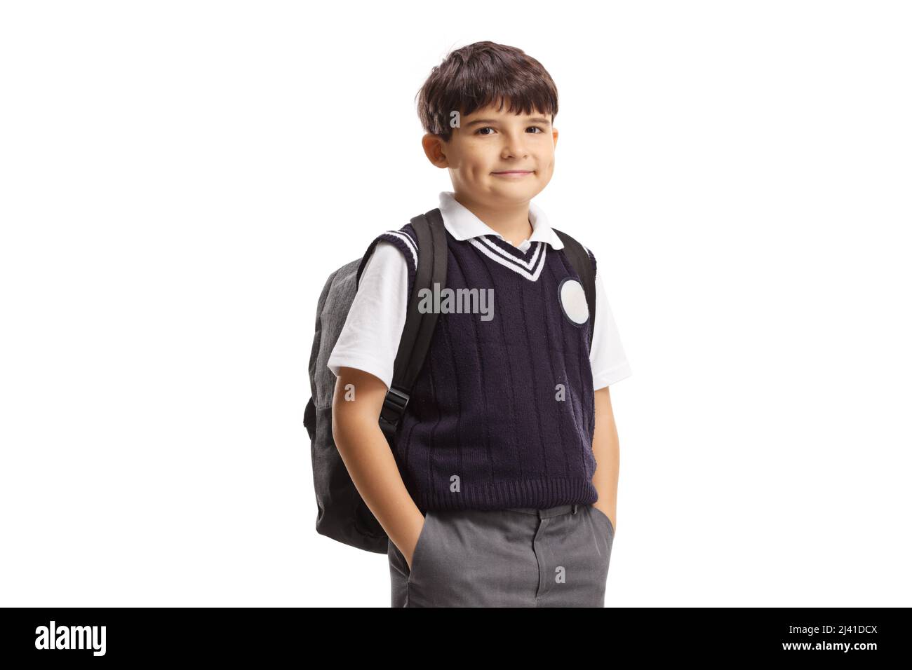 Boy in a school uniform posing with hands in pockets isolated on white ...
