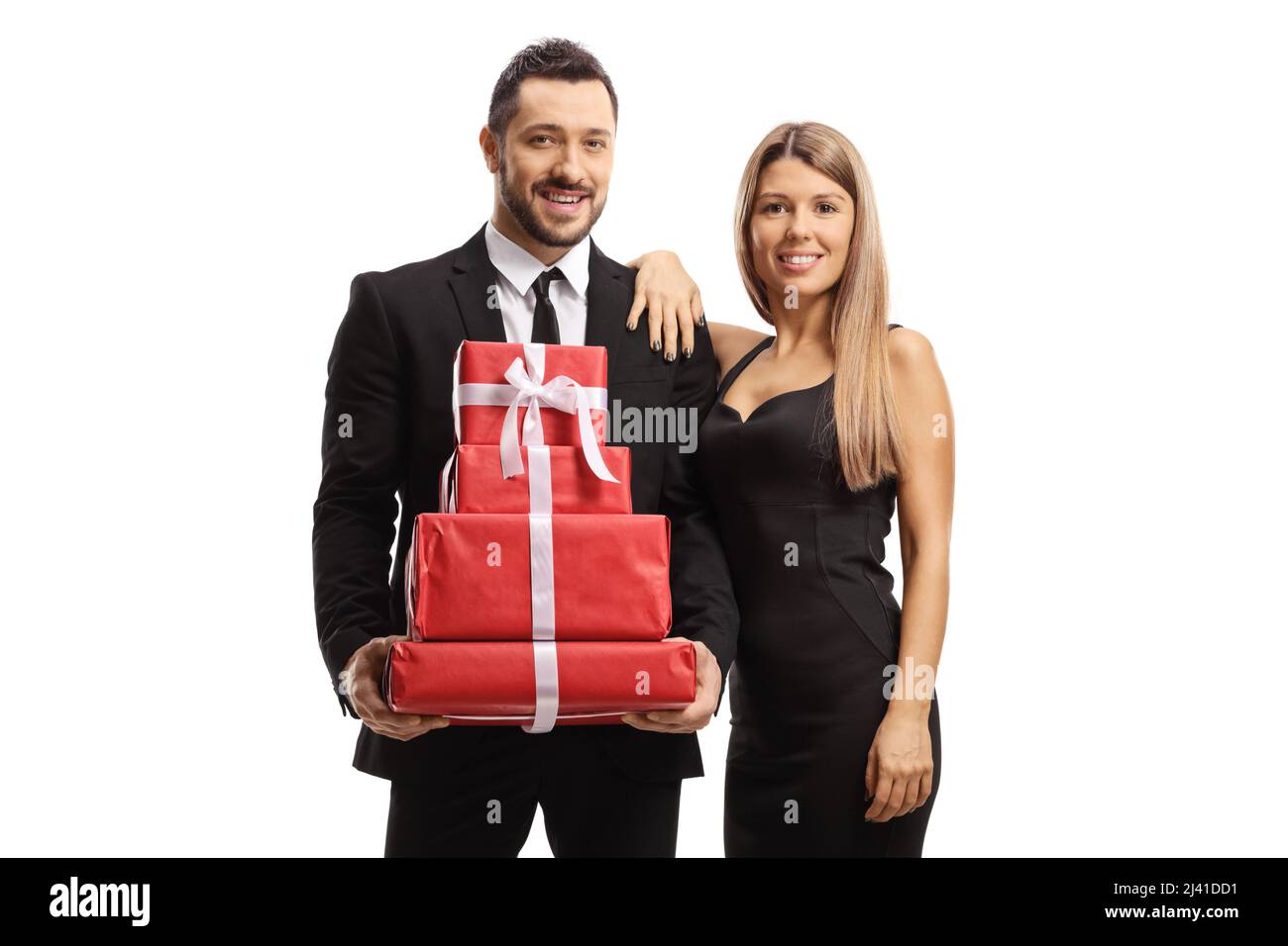 Young couple in elegant clothes with a pile of presents isolated on ...