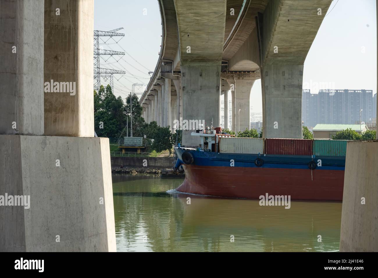 vessel with containers passing a bridge Stock Photo - Alamy