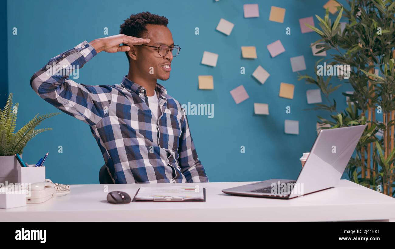 Company employee doing military salute with hand over temple, showing ...
