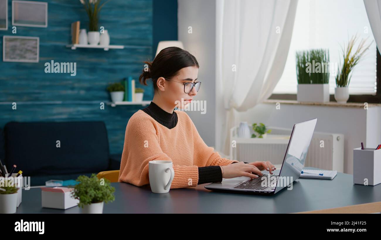 Female student typing on laptop to do remote school work, planning ...