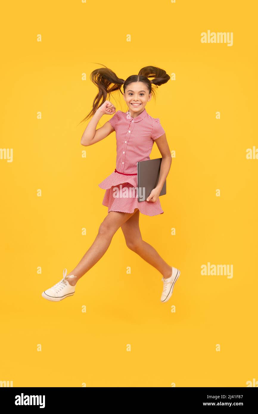 happy kid girl jumping with laptop go successful online shopping, sale ...